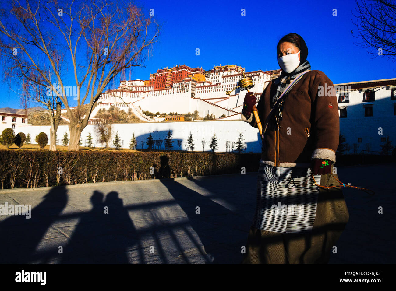 Pilgrim Tibetan woman walking the Kora around Potala palace. Lhasa ...