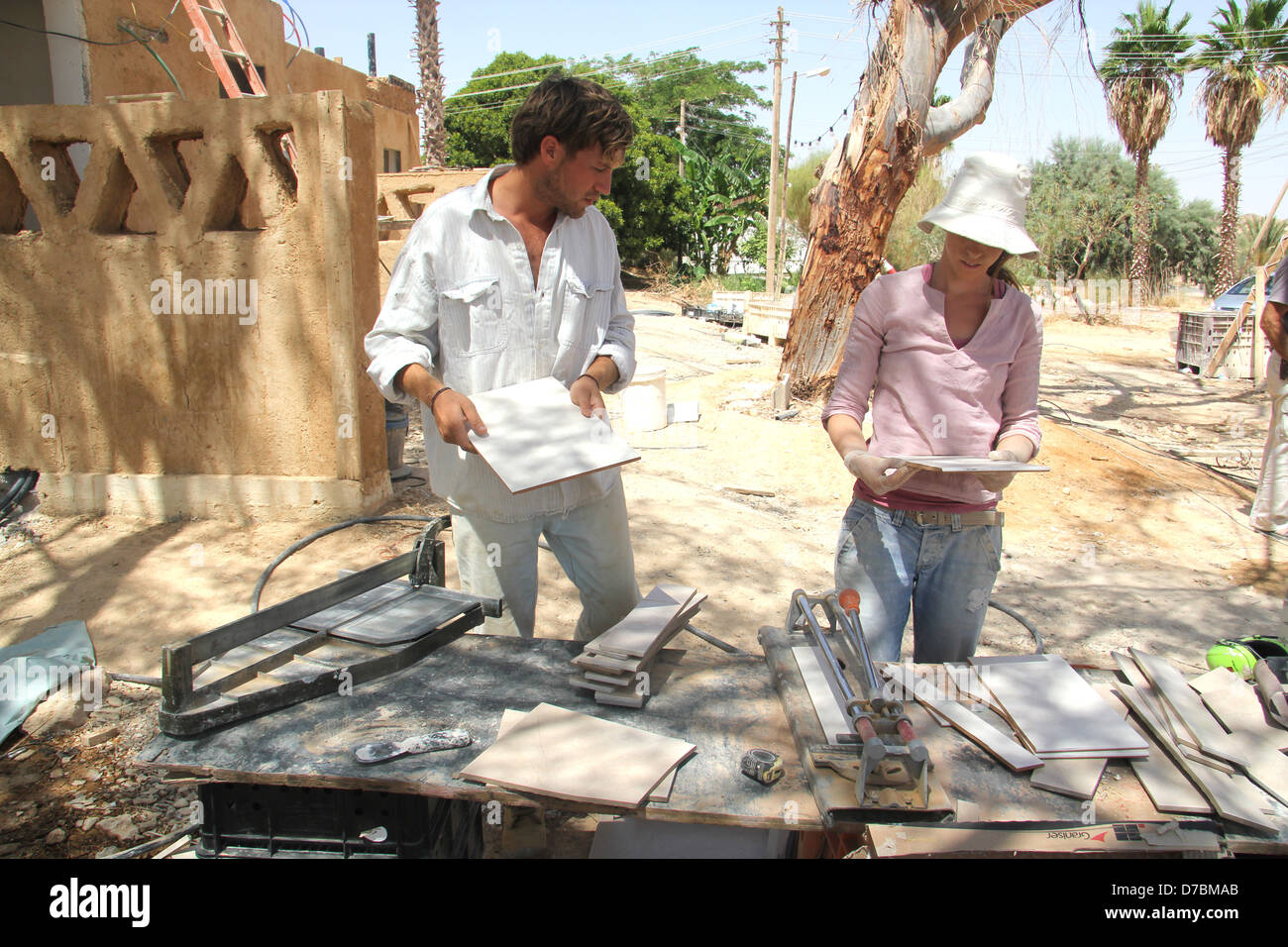 Male and Female workers engaged in ecological building in Kibbutz Neot ...