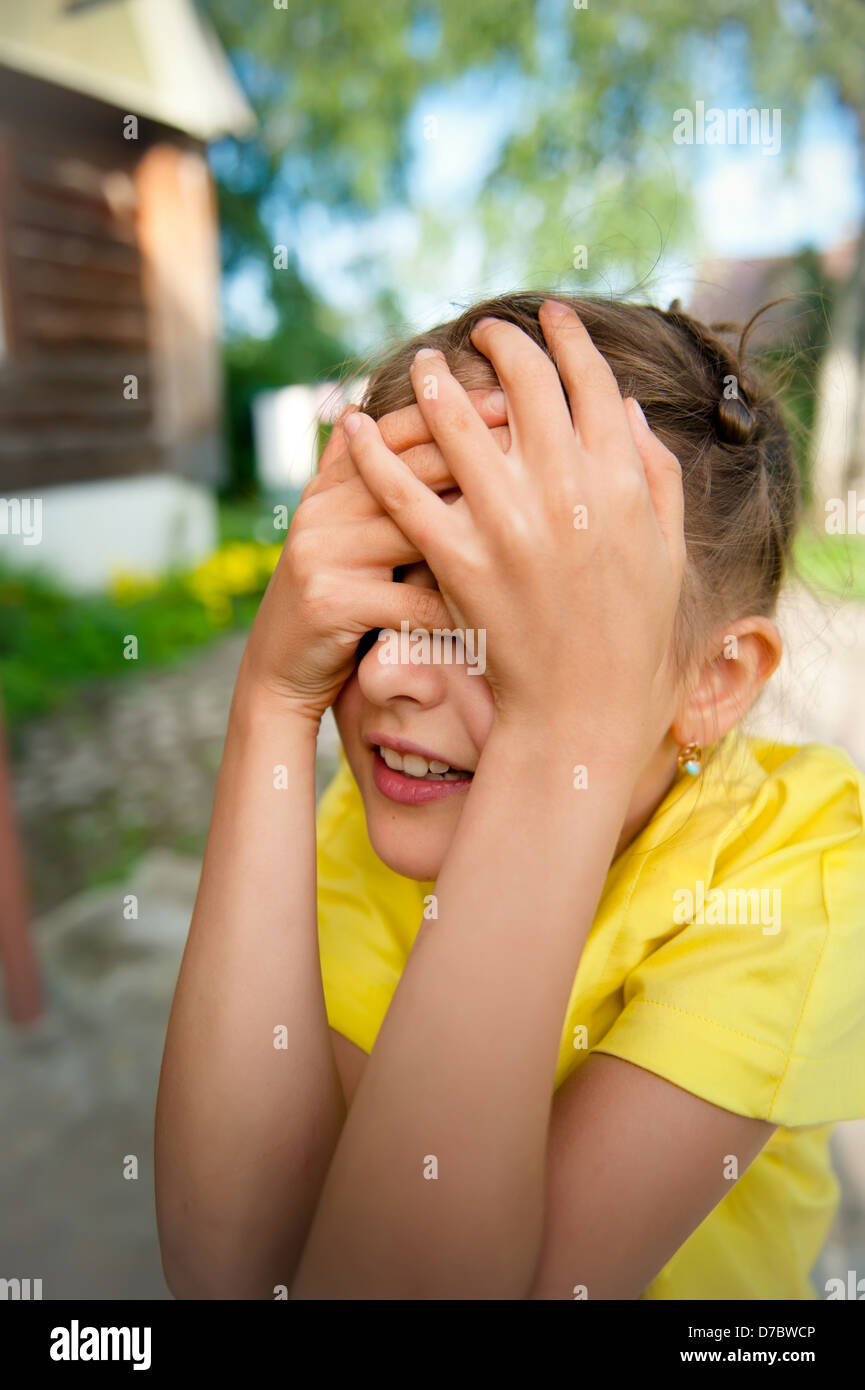 Hiding face behind fingers hi-res stock photography and images - Alamy