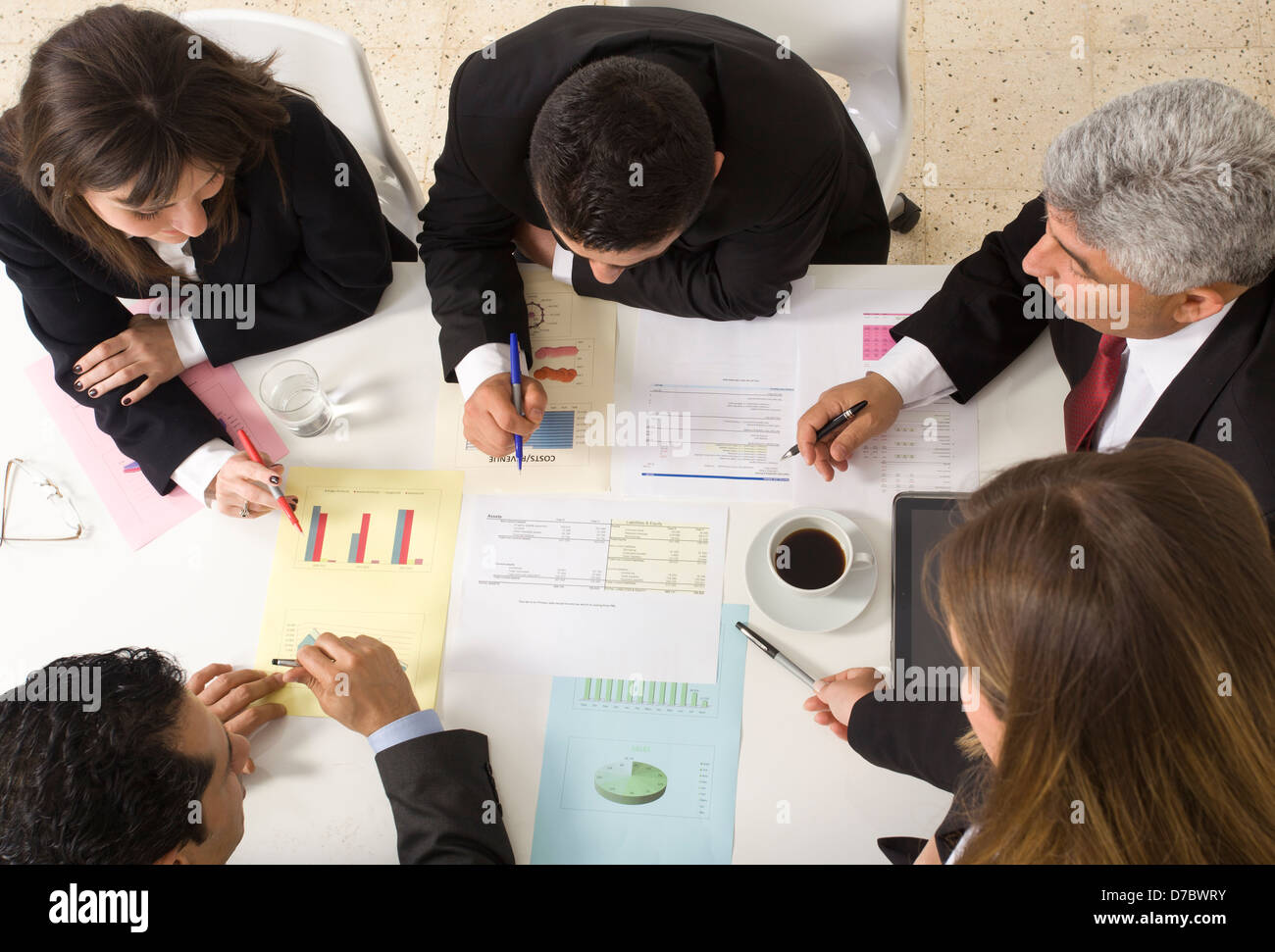 Businesspeople working together at meeting, discussing document Stock Photo - Alamy