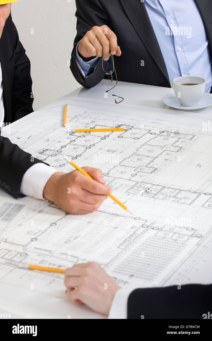 Architect at the table with blueprint Stock Photo - Alamy