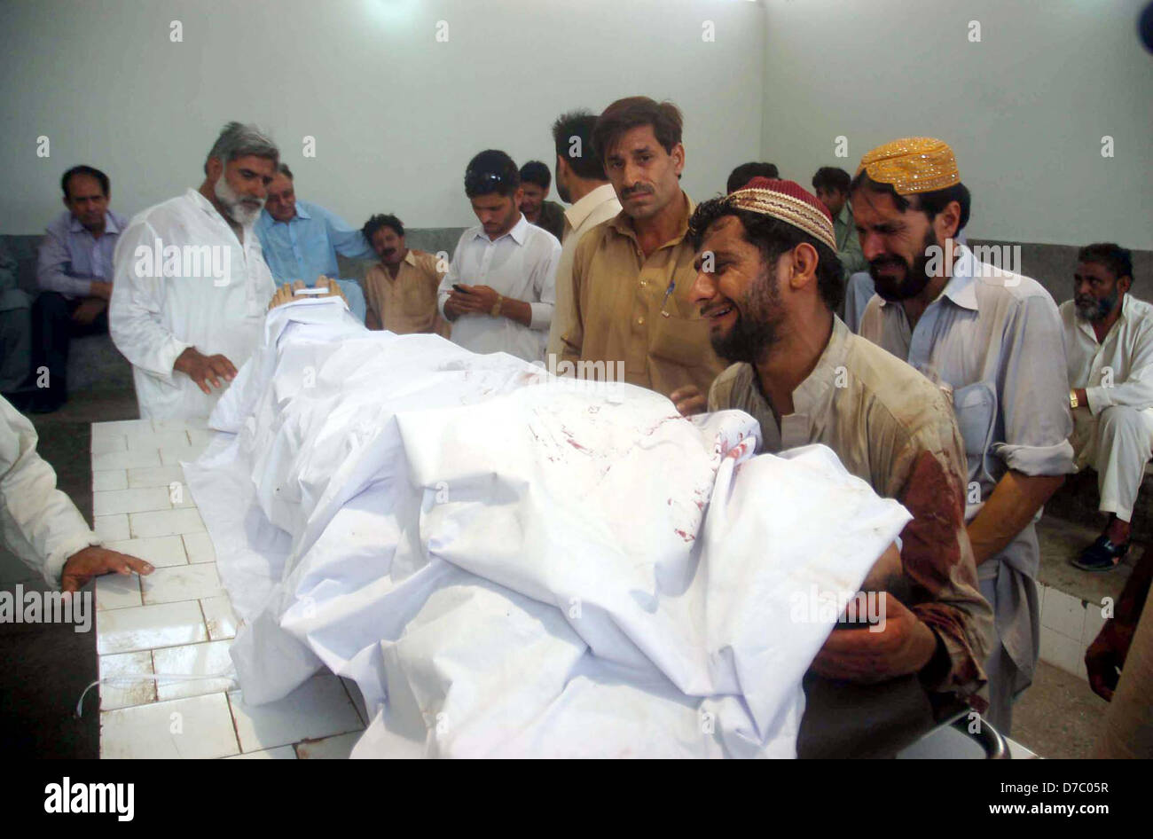 People gather near dead body of Awami National Party (ANP) candidate ...