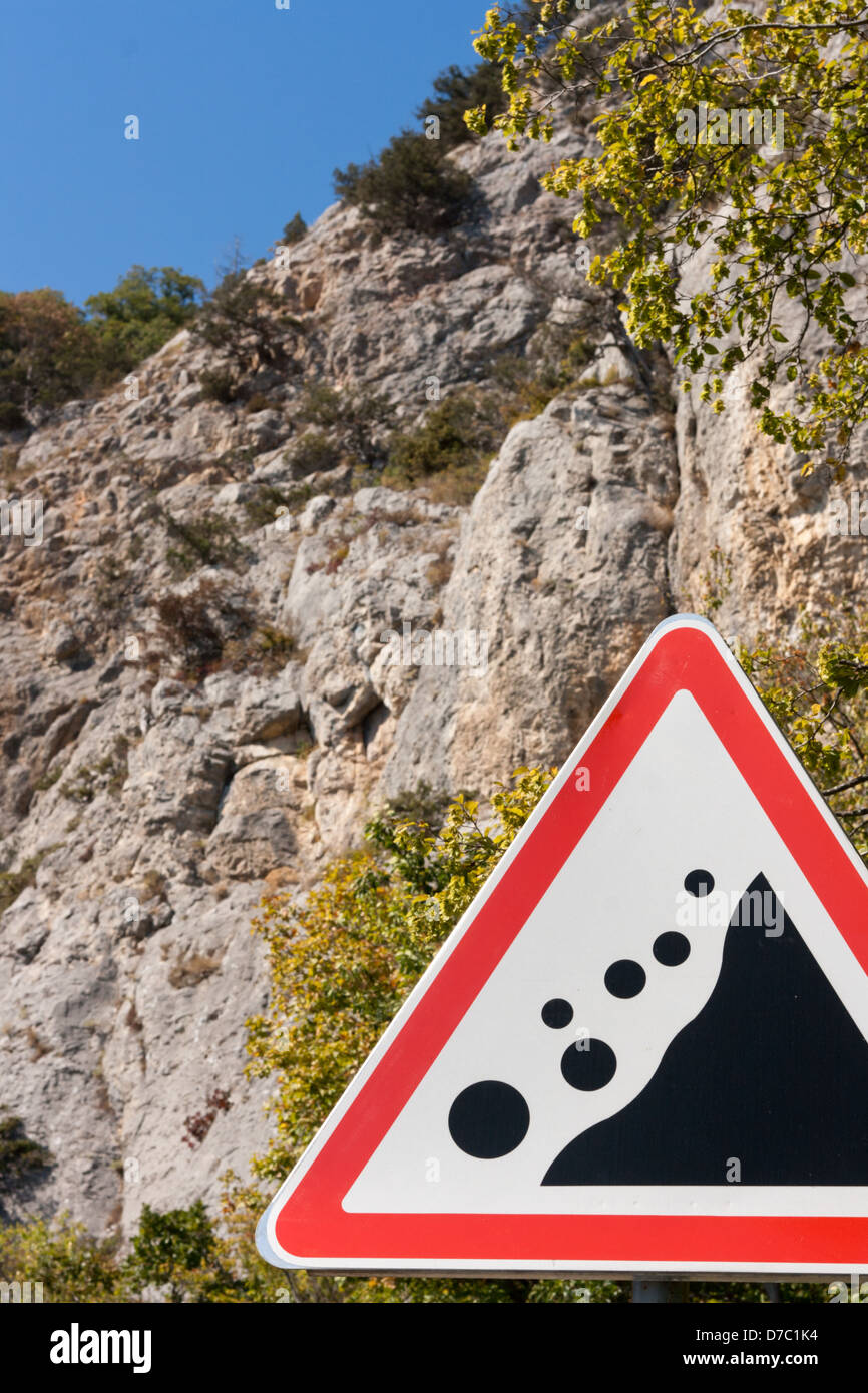 Road sign waring about falling stones, rocks, landslide Stock Photo - Alamy