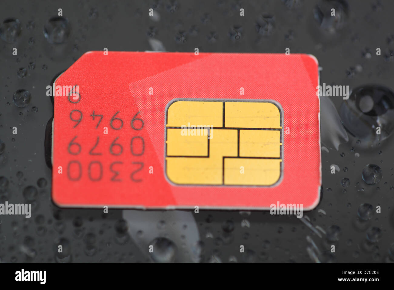 Sim card on a black background with drops Stock Photo - Alamy