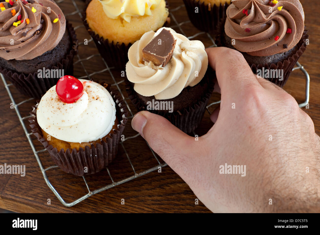 Close up of some decadent gourmet cupcakes frosted with a variety of ...