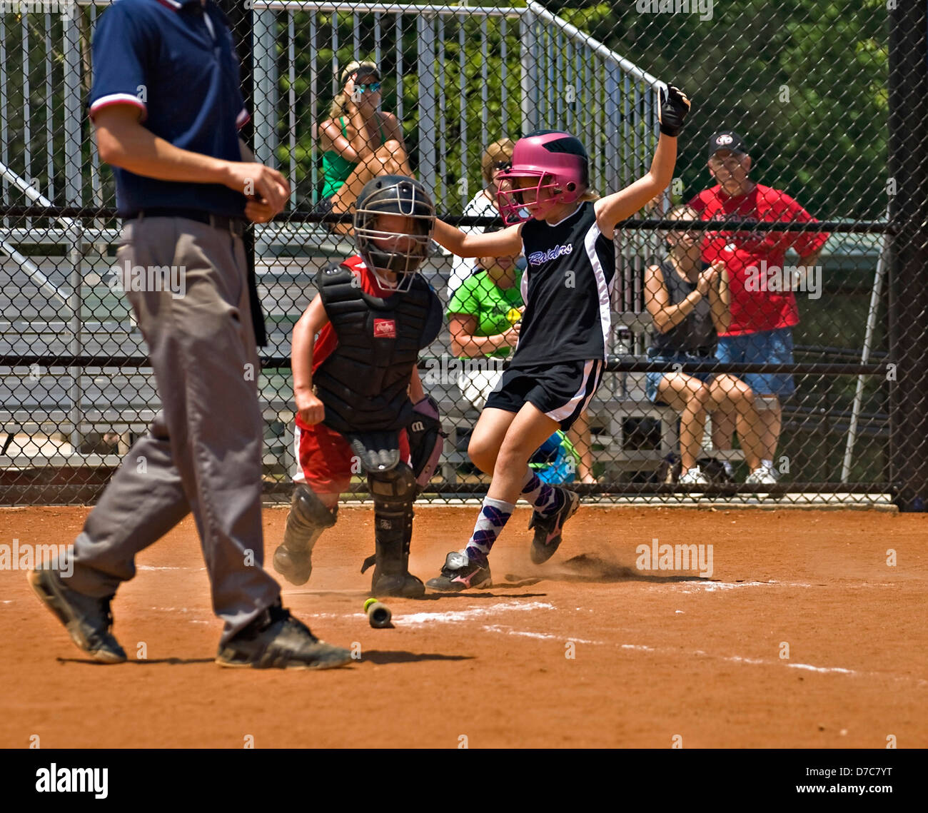 Young girl making a run to home during a softball game Stock Photo - Alamy