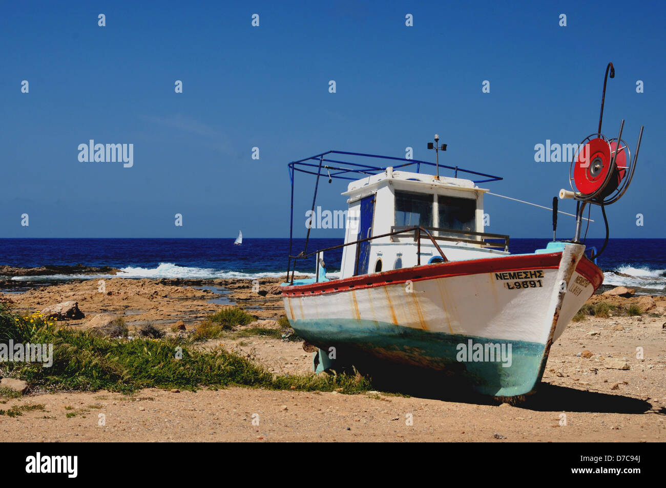 Beach scene with traditional fishing boat, Cyprus Stock Photo - Alamy