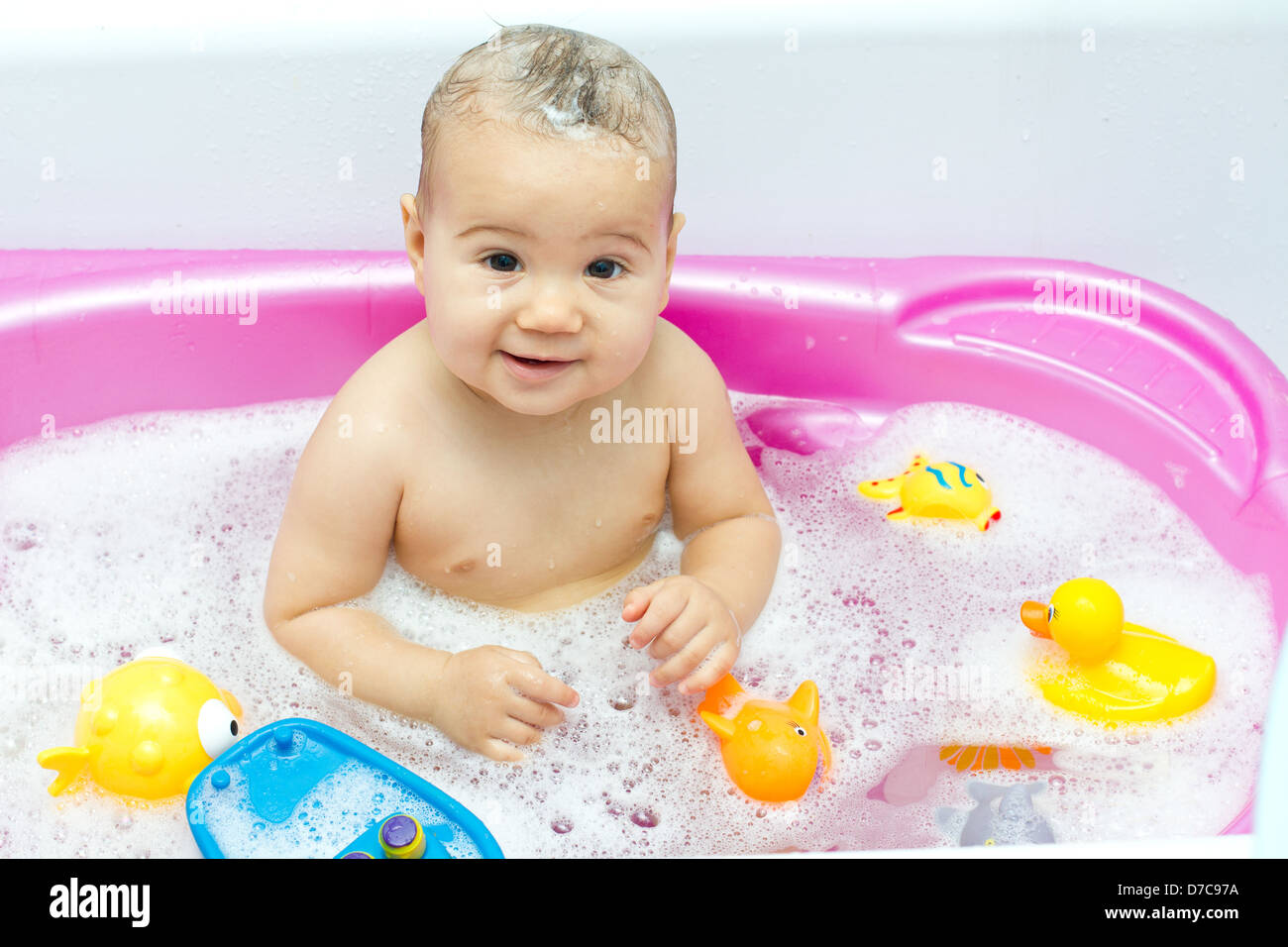 Adorable baby having fun while bath time Stock Photo - Alamy