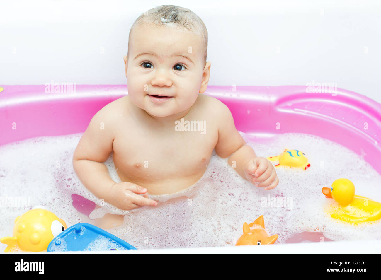 Adorable baby having fun while bath time Stock Photo - Alamy