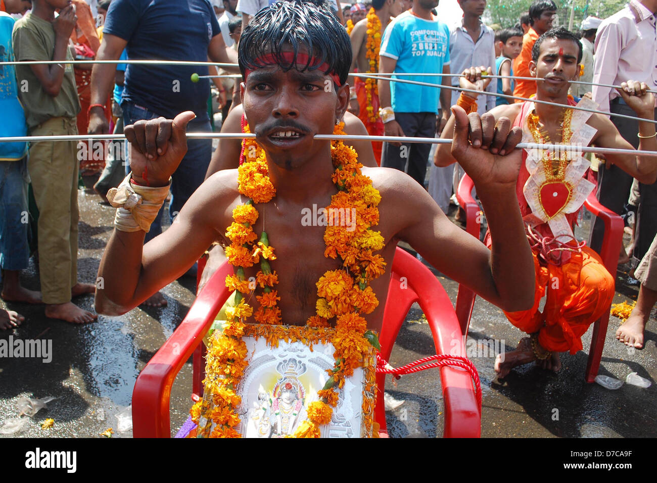 Hindu devotees of Devi Maha Mariamman get their cheeks pierced by a rod ...