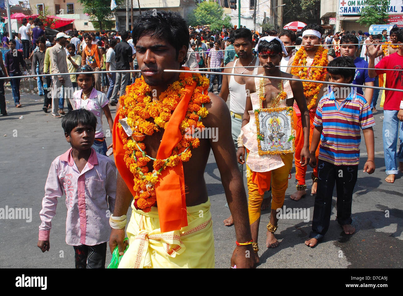 Hindu devotees of Devi Maha Mariamman get their cheeks pierced by a rod ...