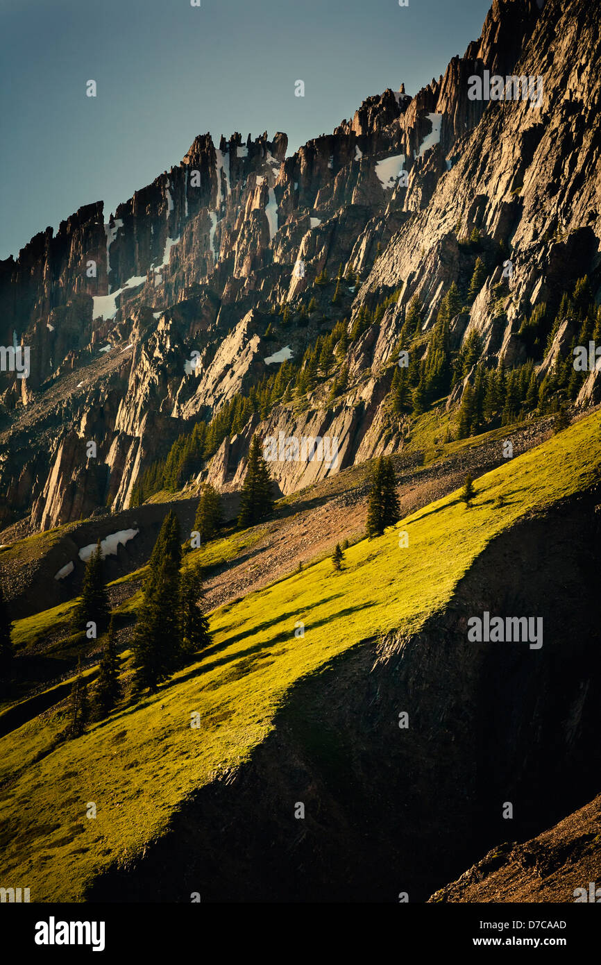 Warm grassy slopes and rocky crags of elpoca mountain;Kananaskis ...