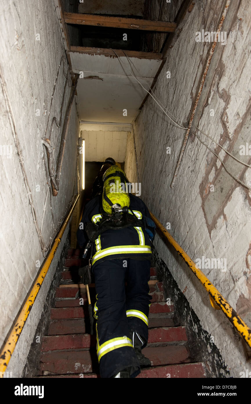 Firefighter climbing stairs in BA Breathing Apparatus Stock Photo - Alamy