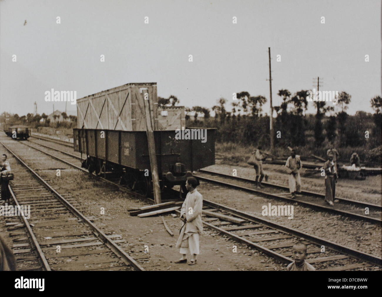 A scene showing a boxcar and people near train tracks. Boxcars are ...