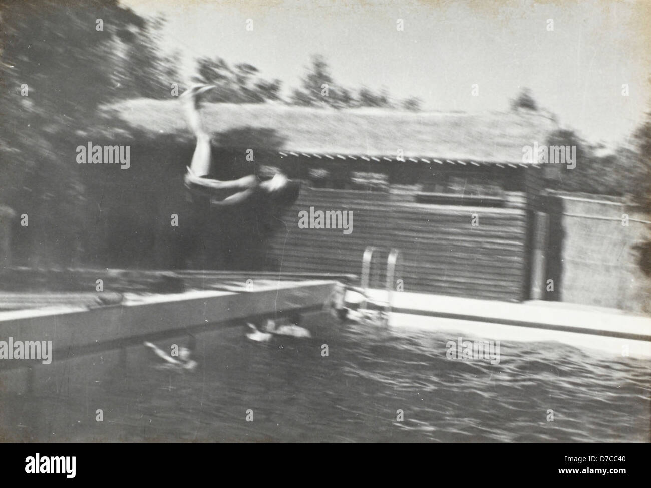 This photograph captures a swimmer in mid-flip during a dive or ...
