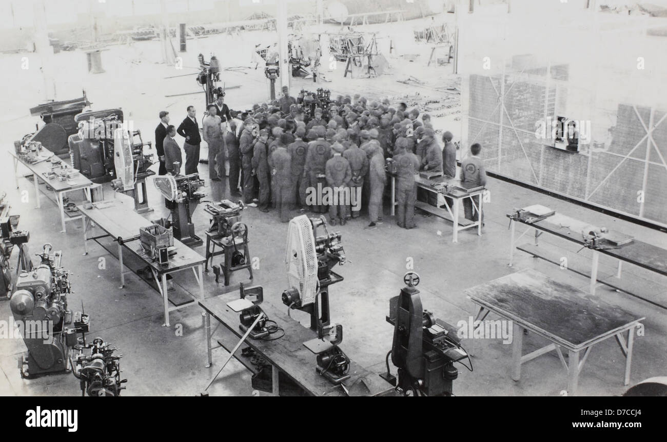 A factory floor meeting focuses on discussing operations, production ...