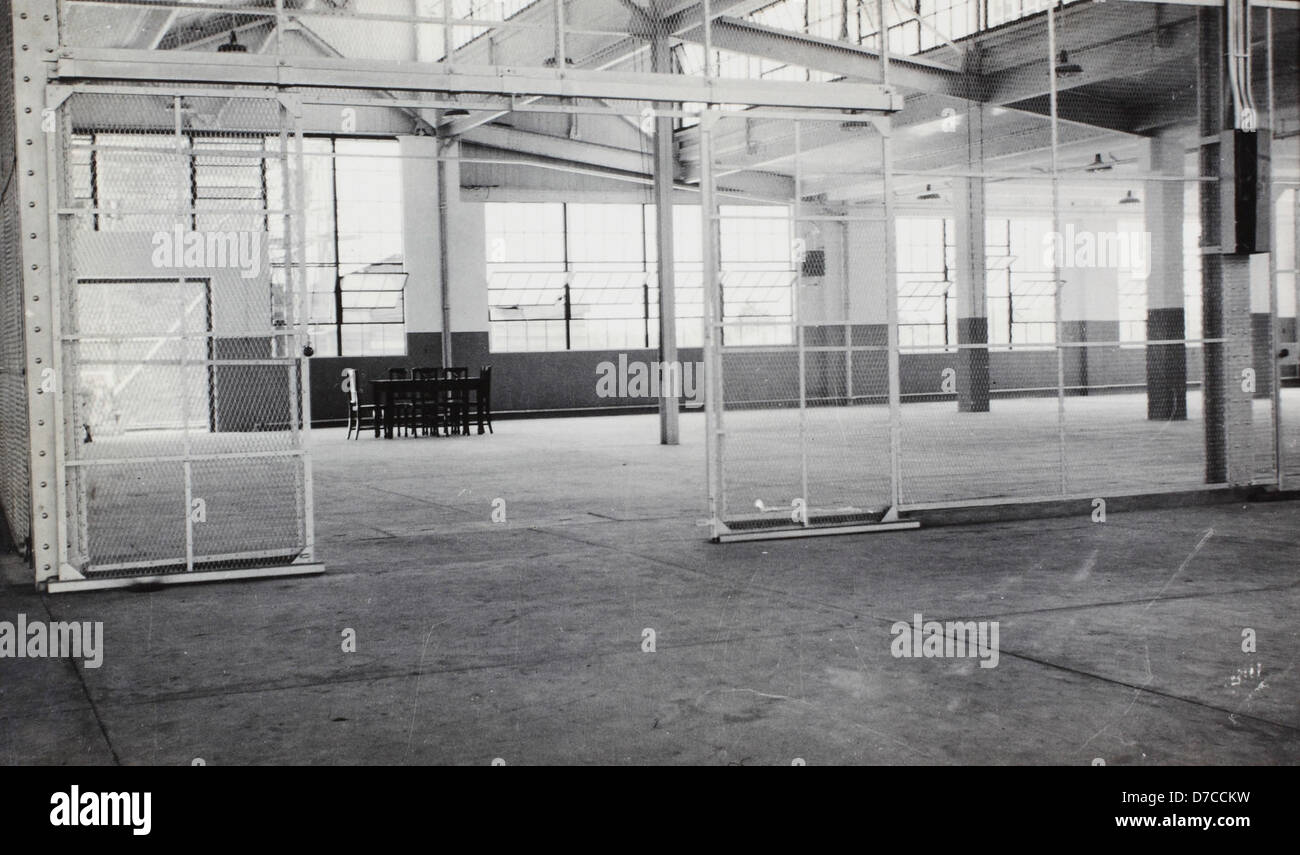 A photograph of a factory interior with a dinner table setup, likely ...