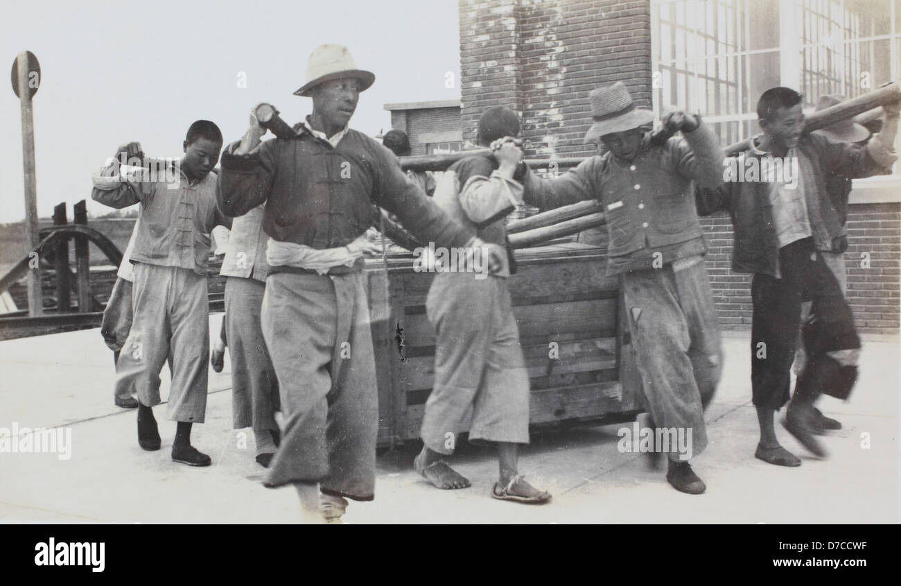 Workers Transporting Materials Stock Photo - Alamy
