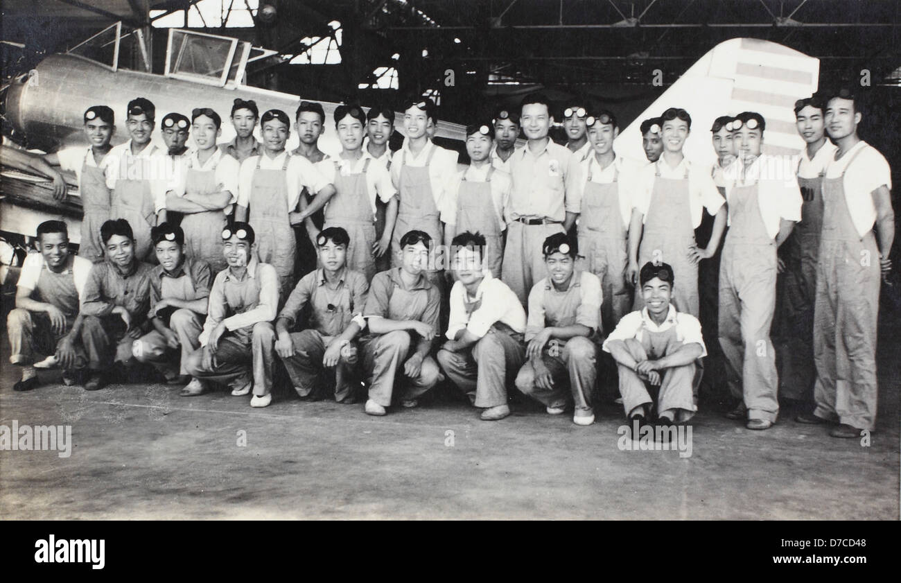 This photograph captures a group of workers engaged in welding ...