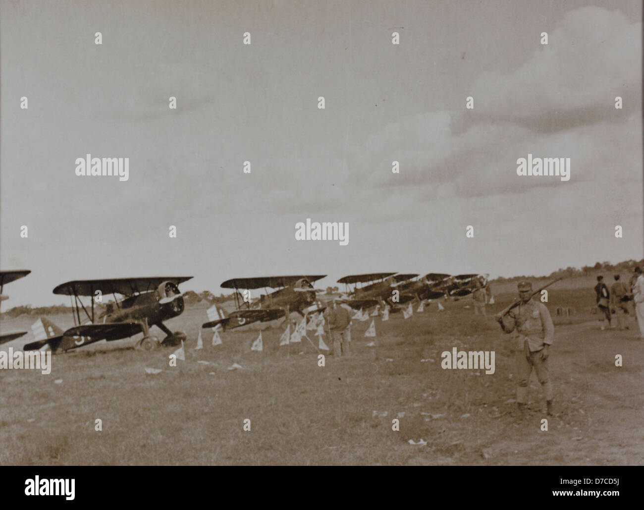 This photograph captures a view of an active flying field, showing ...