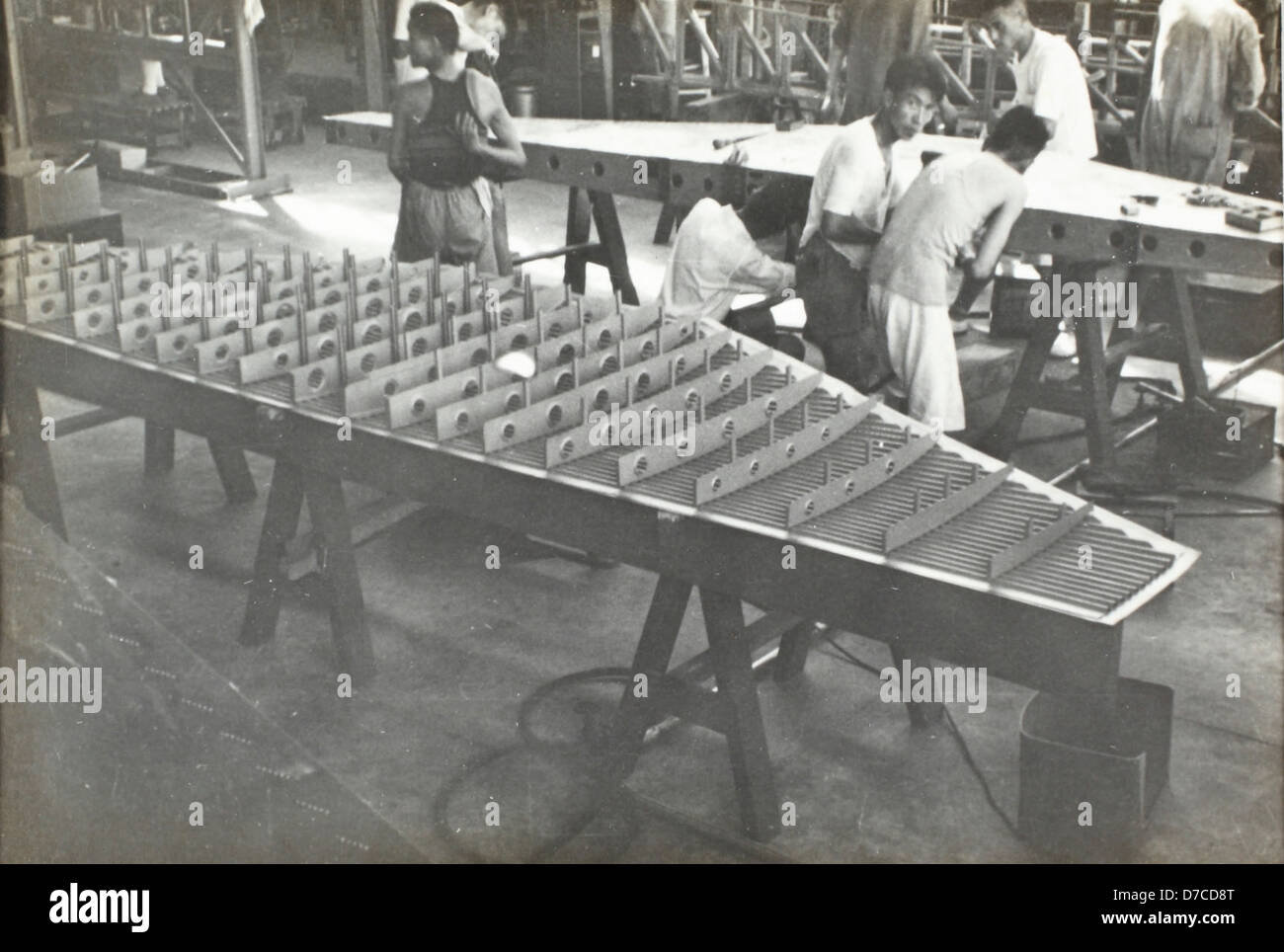 This image shows the construction process of an aircraft, likely in a ...