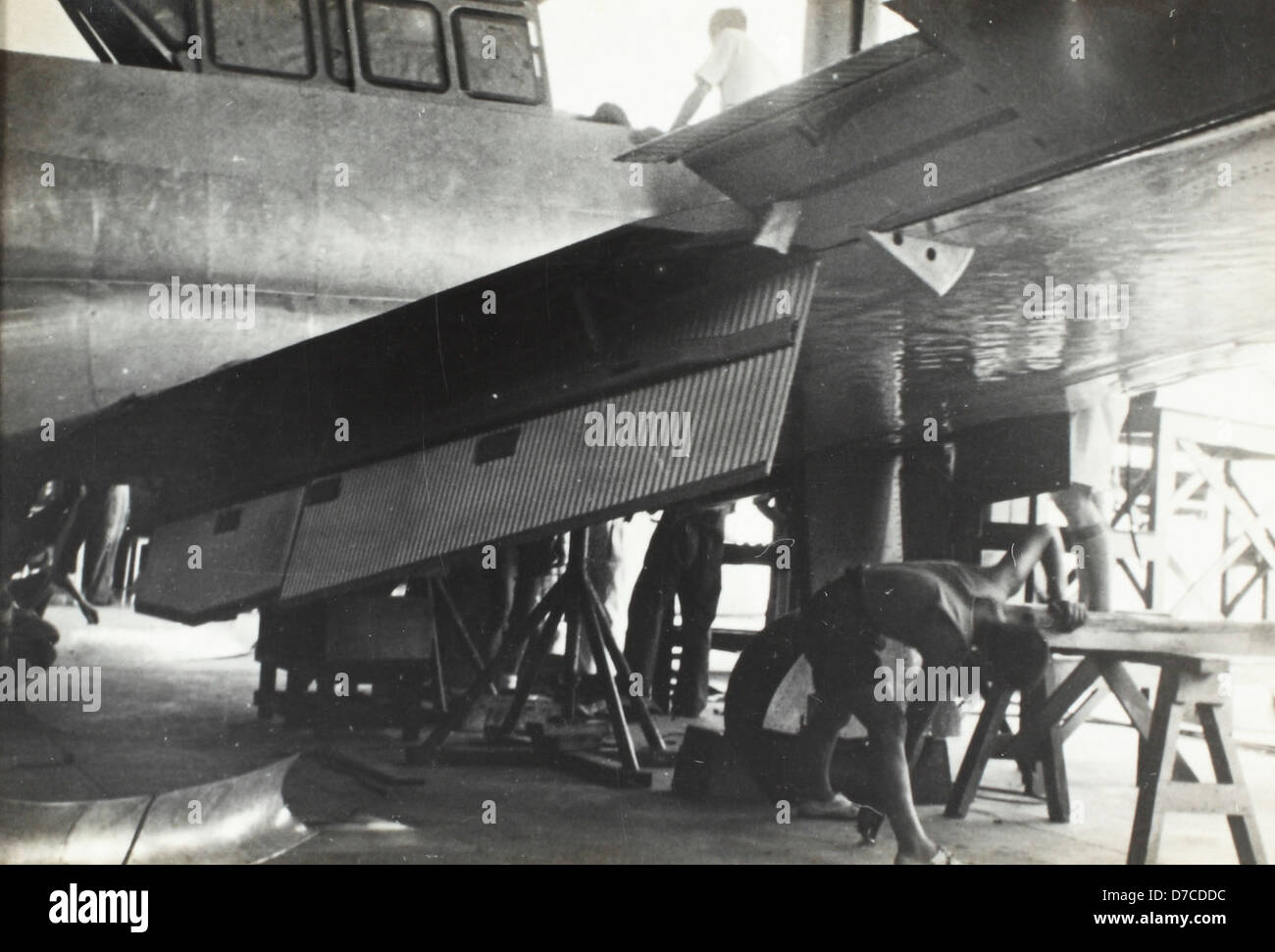 This image shows workers assembling a plane in a production facility ...