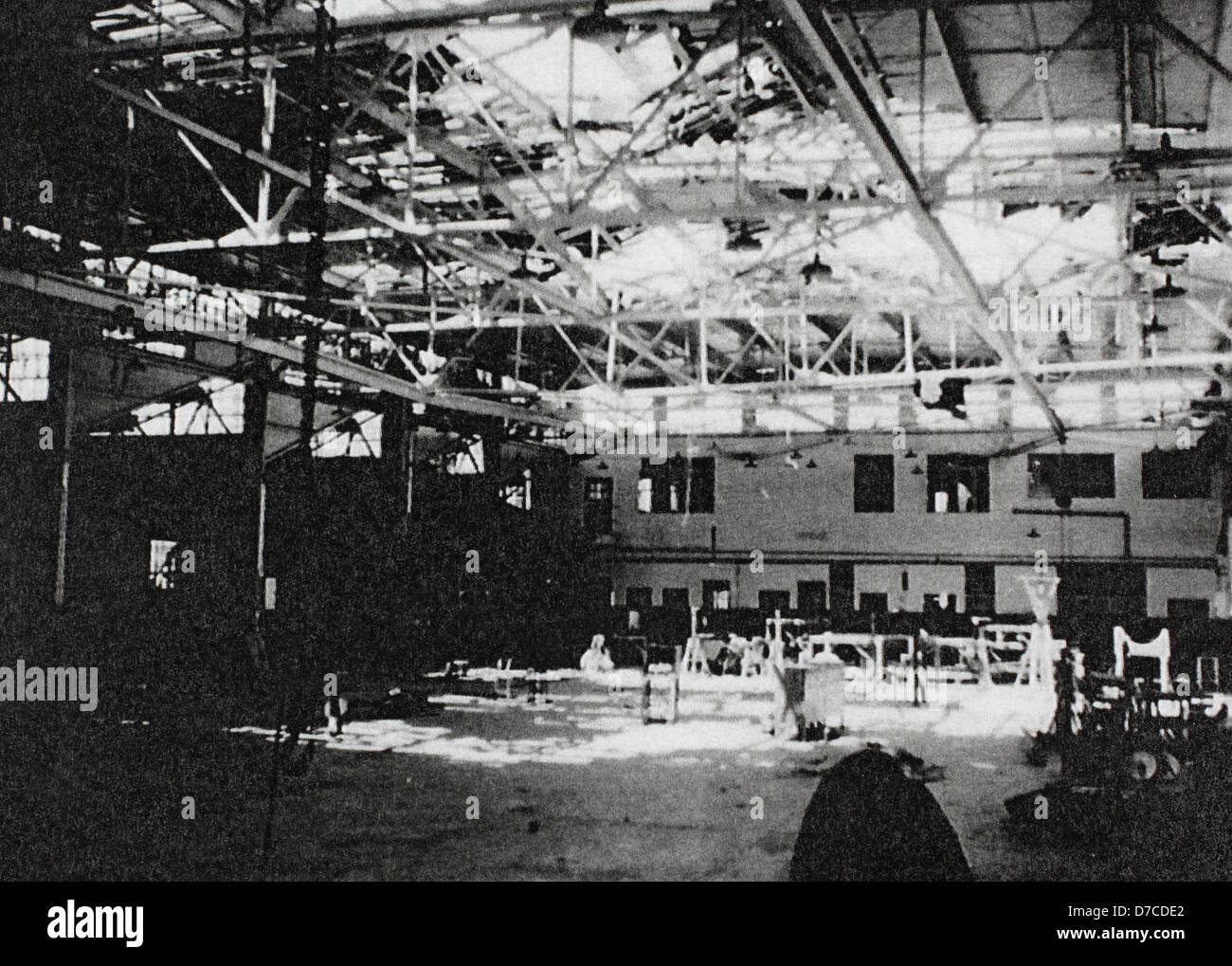 A photograph depicting the interior of a factory following a bombing ...