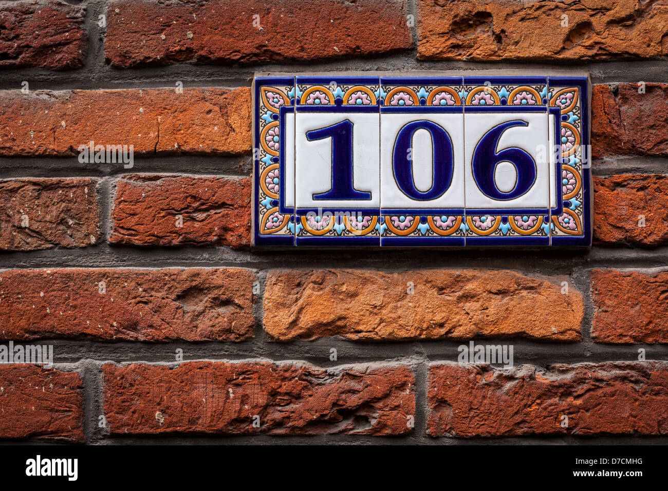 Number 106 on the red brick wall background Stock Photo - Alamy