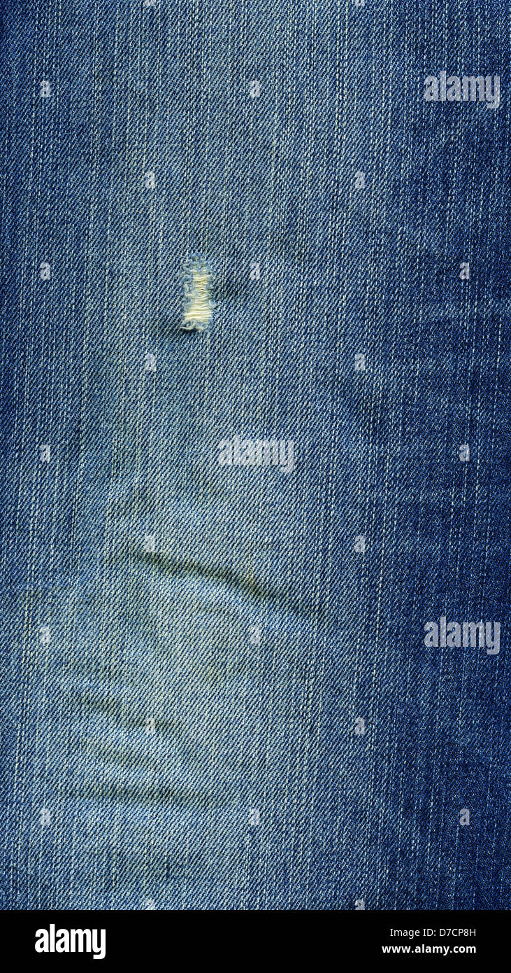 High resolution scan of blue denim fabric with a worn-out look. Scanned ...