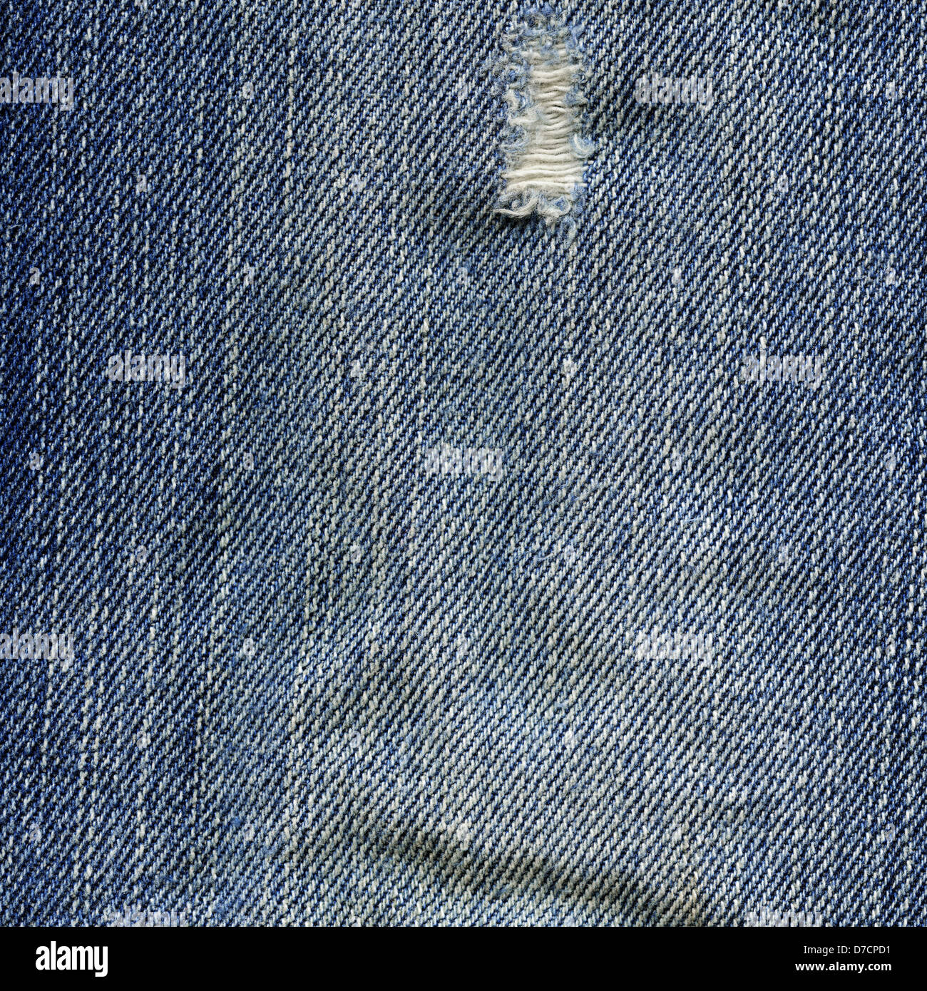 High resolution scan of blue denim fabric with a worn-out look. Scanned ...