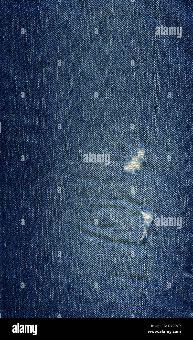 High resolution scan of blue denim fabric with a worn-out look. Scanned ...