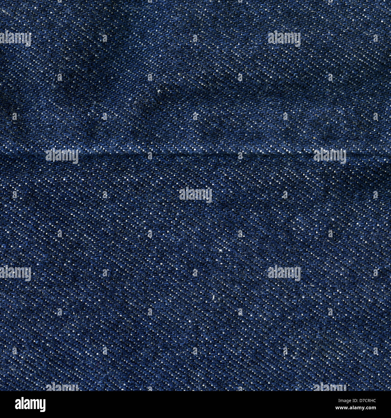 High resolution scan dark blue denim fabric horizontal seam crossing ...