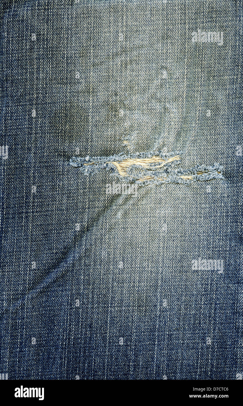 High resolution scan blue denim fabric large rip general worn-out look ...