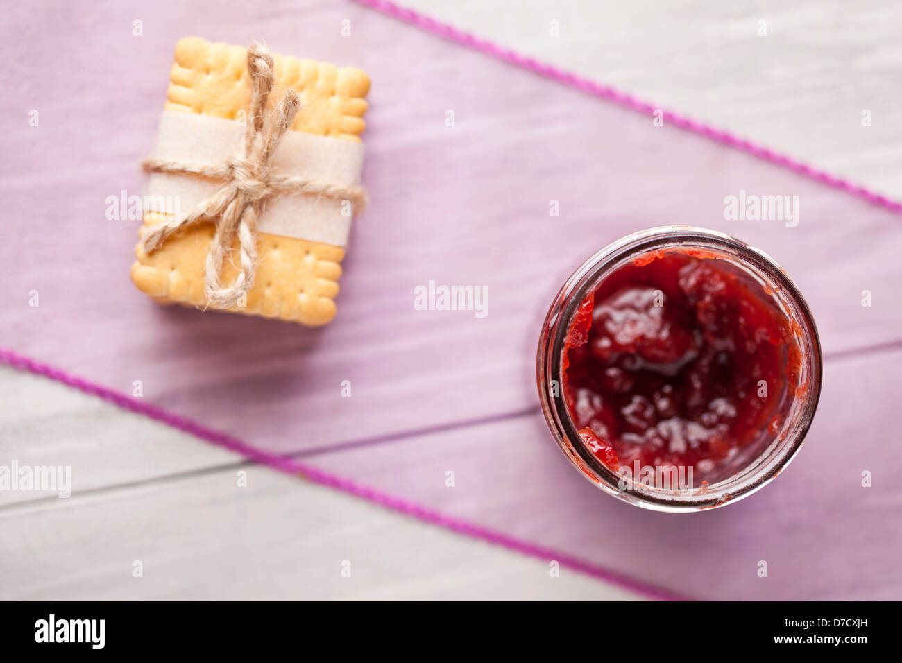 Fresh baked biscuits and red fruit jam Stock Photo - Alamy