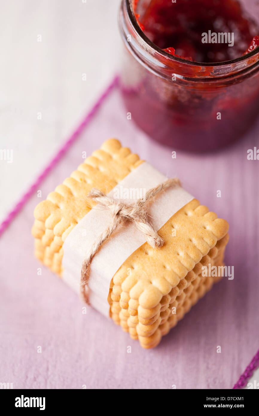 Fresh baked biscuits and red fruit jam Stock Photo - Alamy
