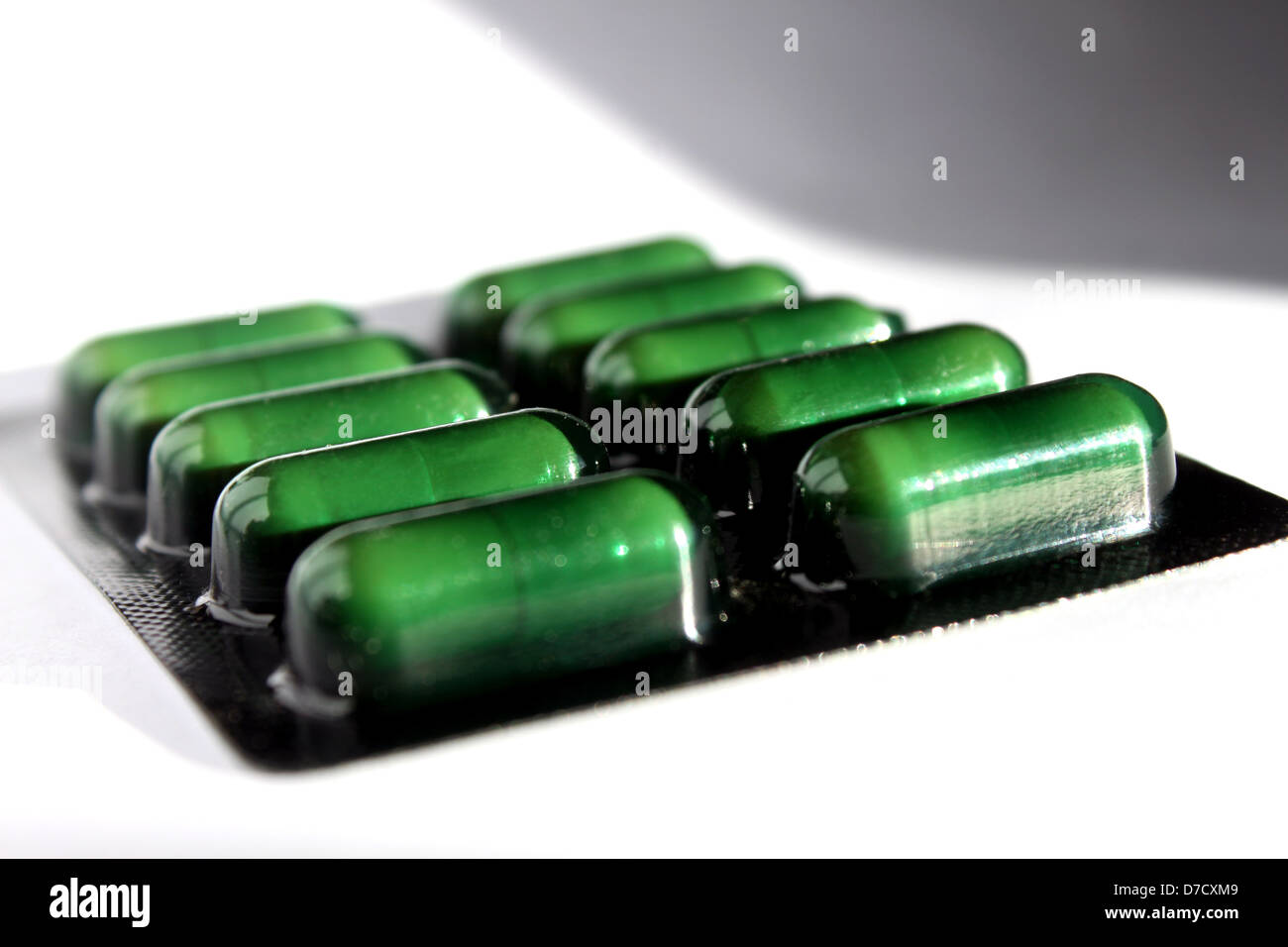 Green drug capsules in original packing Stock Photo - Alamy