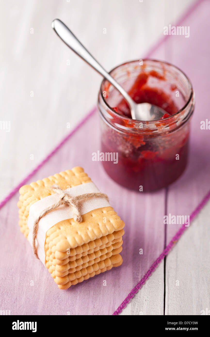 Fresh baked biscuits and red fruit jam Stock Photo - Alamy