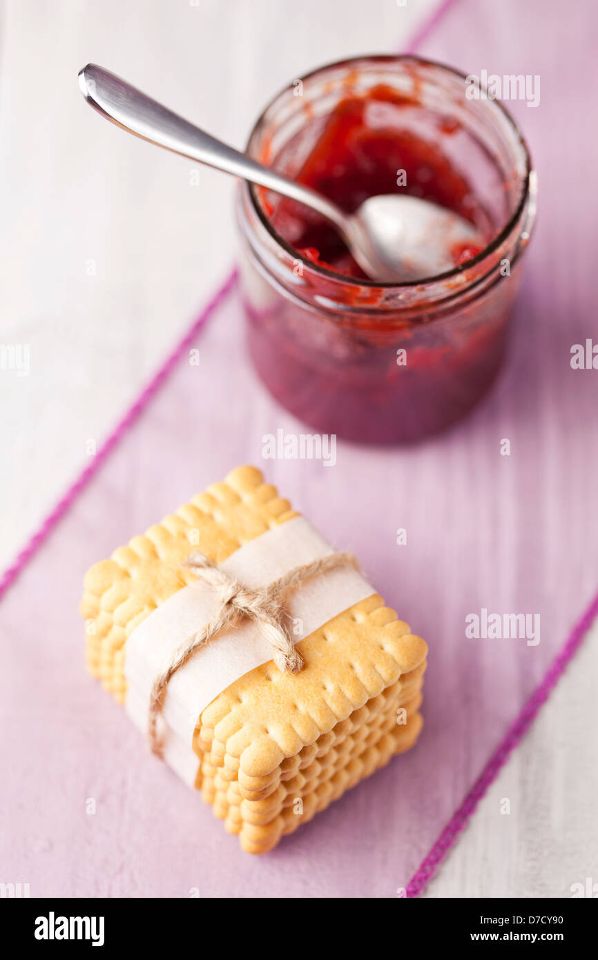 Fresh baked biscuits and red fruit jam Stock Photo - Alamy