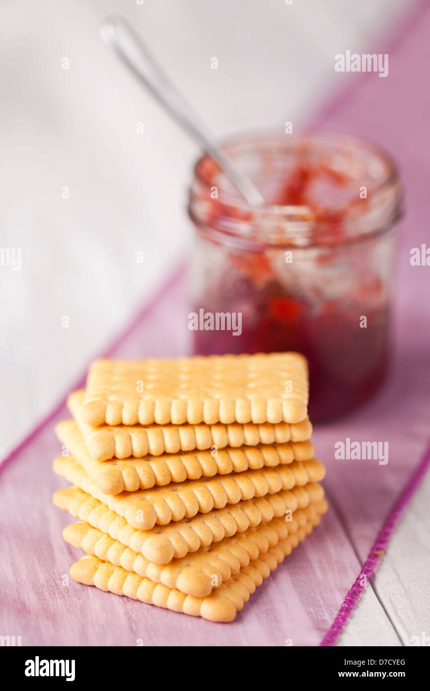 Fresh baked biscuits and red fruit jam Stock Photo - Alamy