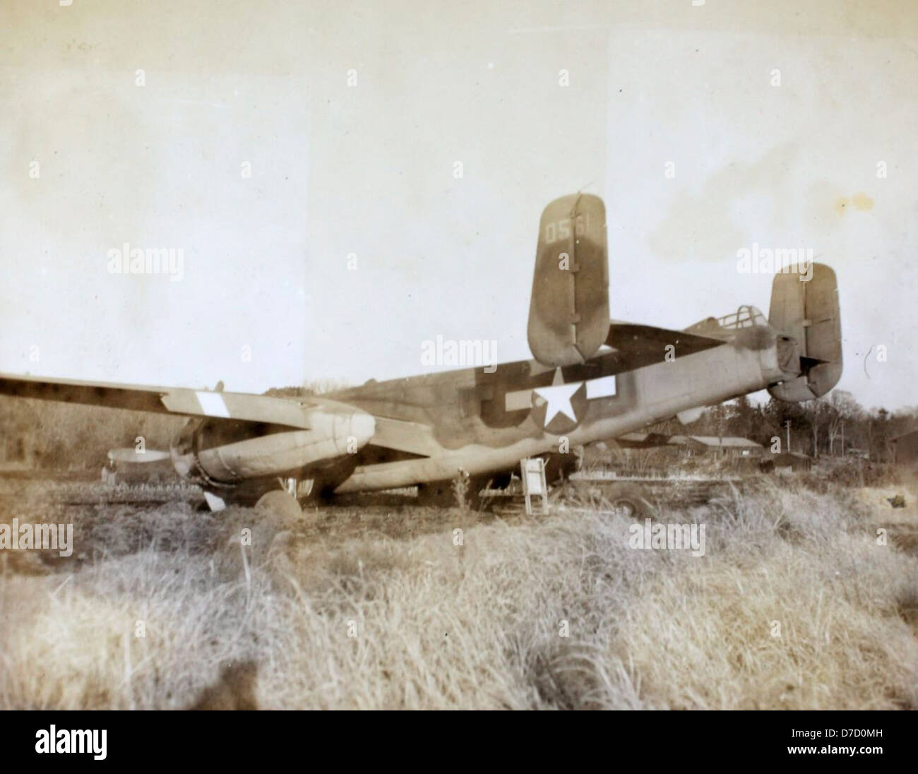 A photograph from Charles Daniels' album showing a B-25 bomber crash ...