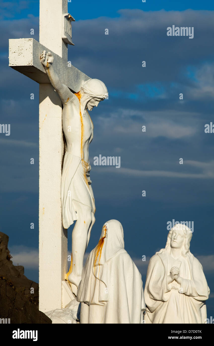 Statue of jesus christ on the cross with two women at the foot of the ...