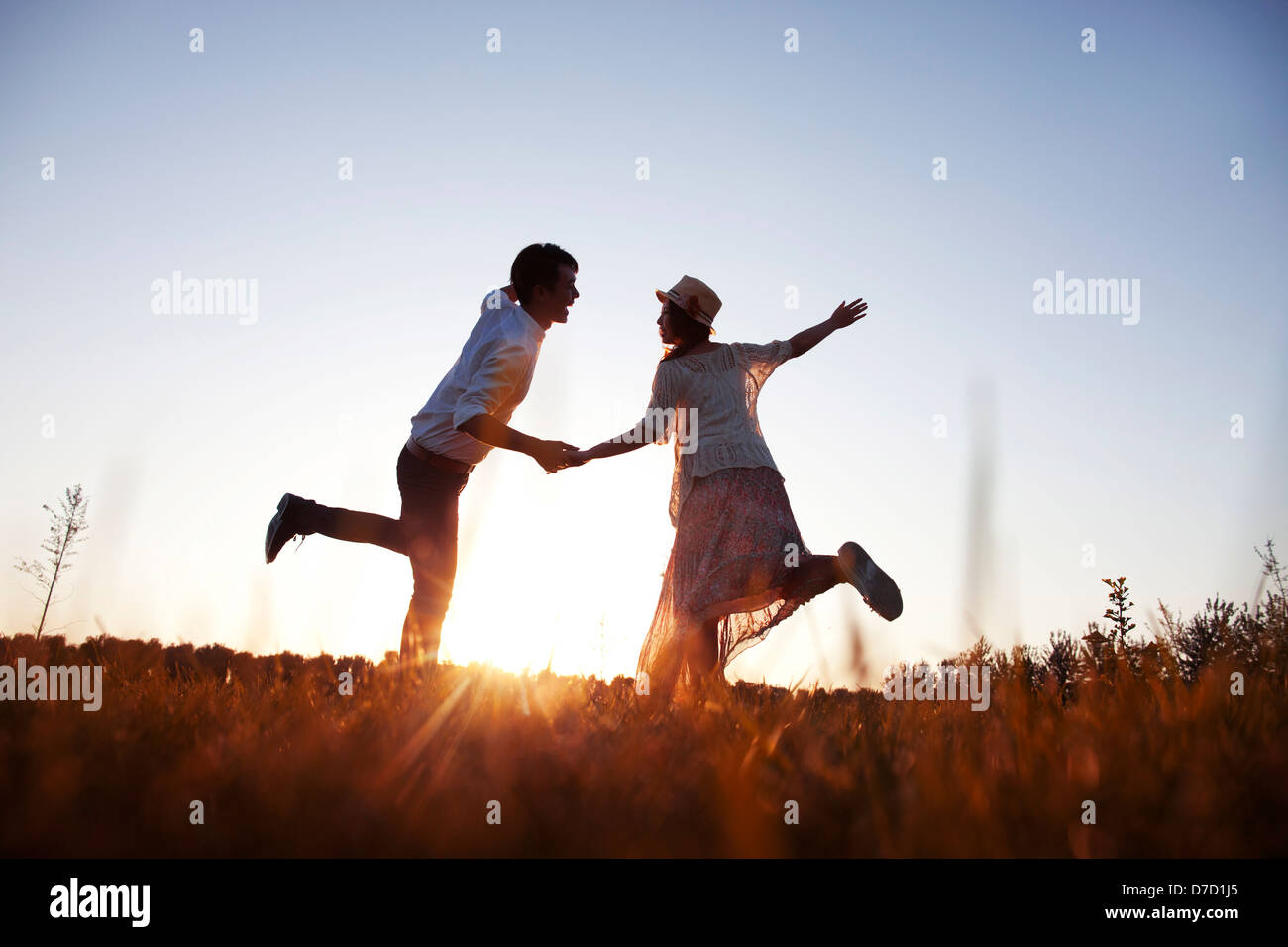 Young couple walking hand in hand Stock Photo - Alamy