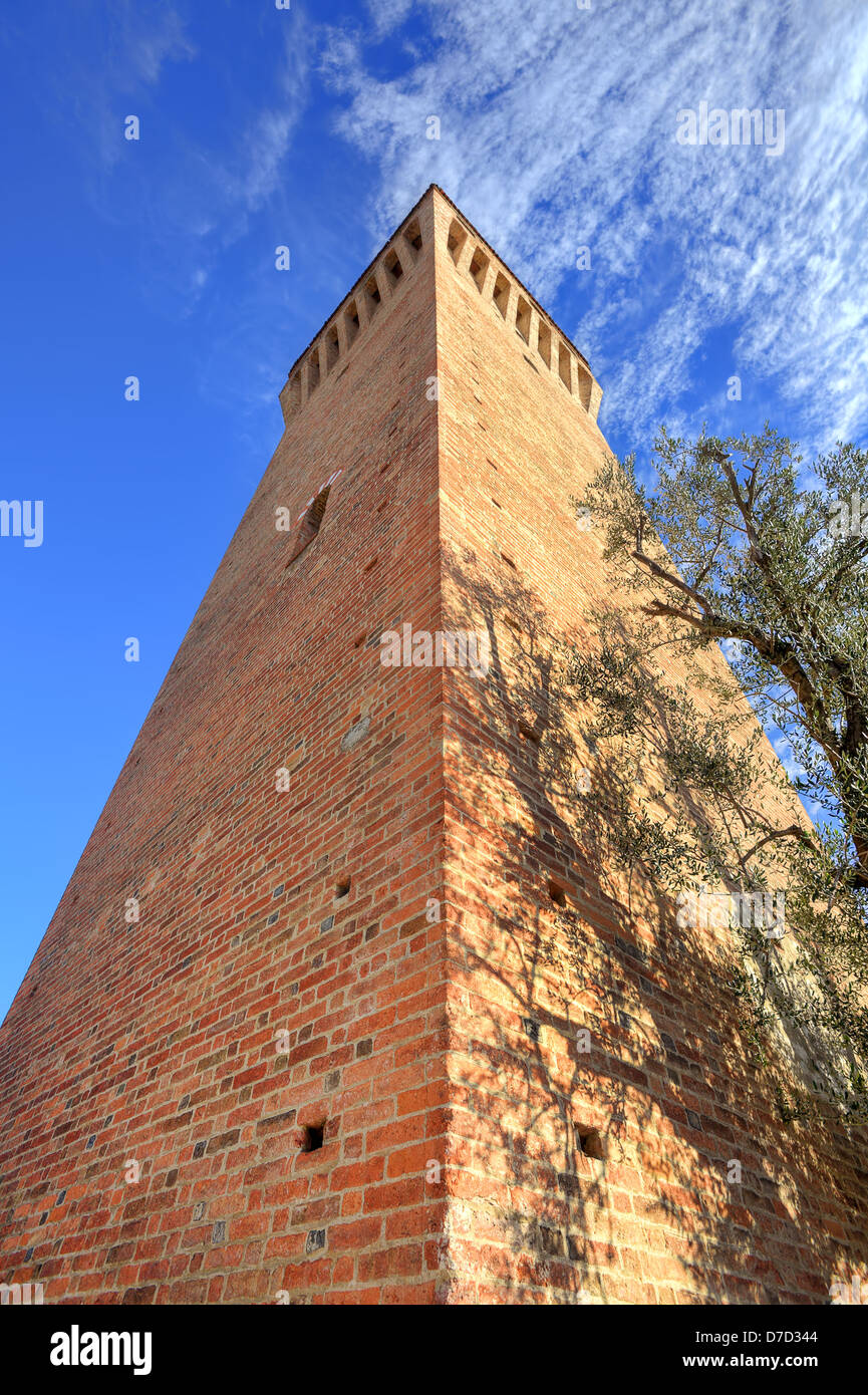 Vertical oriented image of medieval brick tower under blue sky at Santa ...