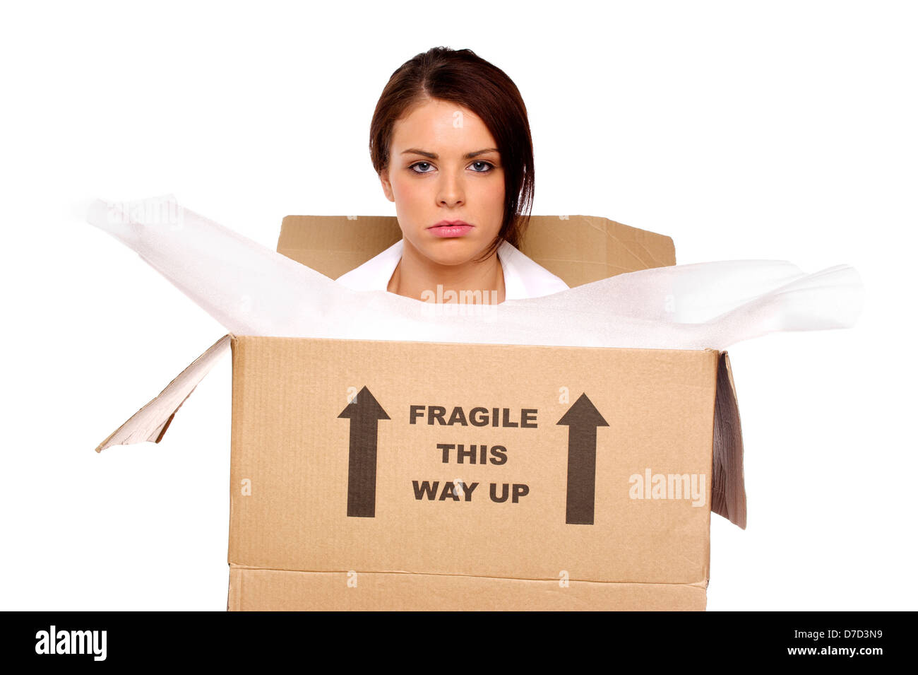 Beautiful business woman stuck in a cardboard box isolated on a white ...