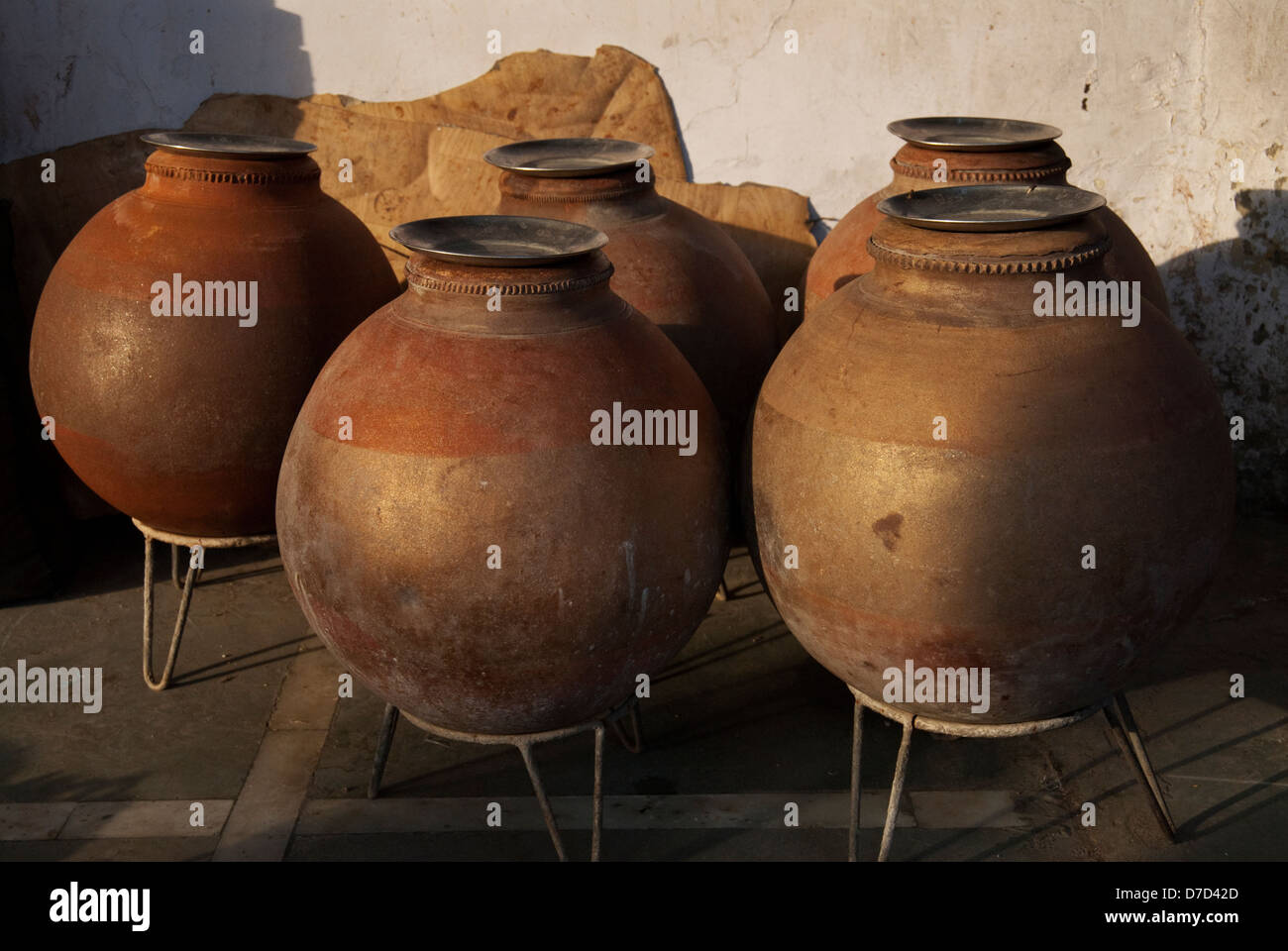 Five large pottery water jars for storing drinking water stand in a ...