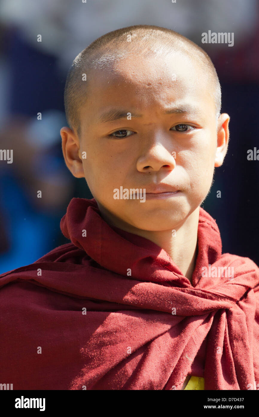 Young novice monk collecting offerings on the streets of Yangon ...