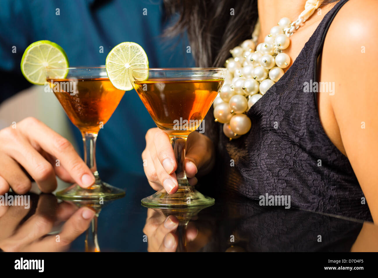 Man and woman flirting intimately at bar drinking cocktails Stock Photo ...