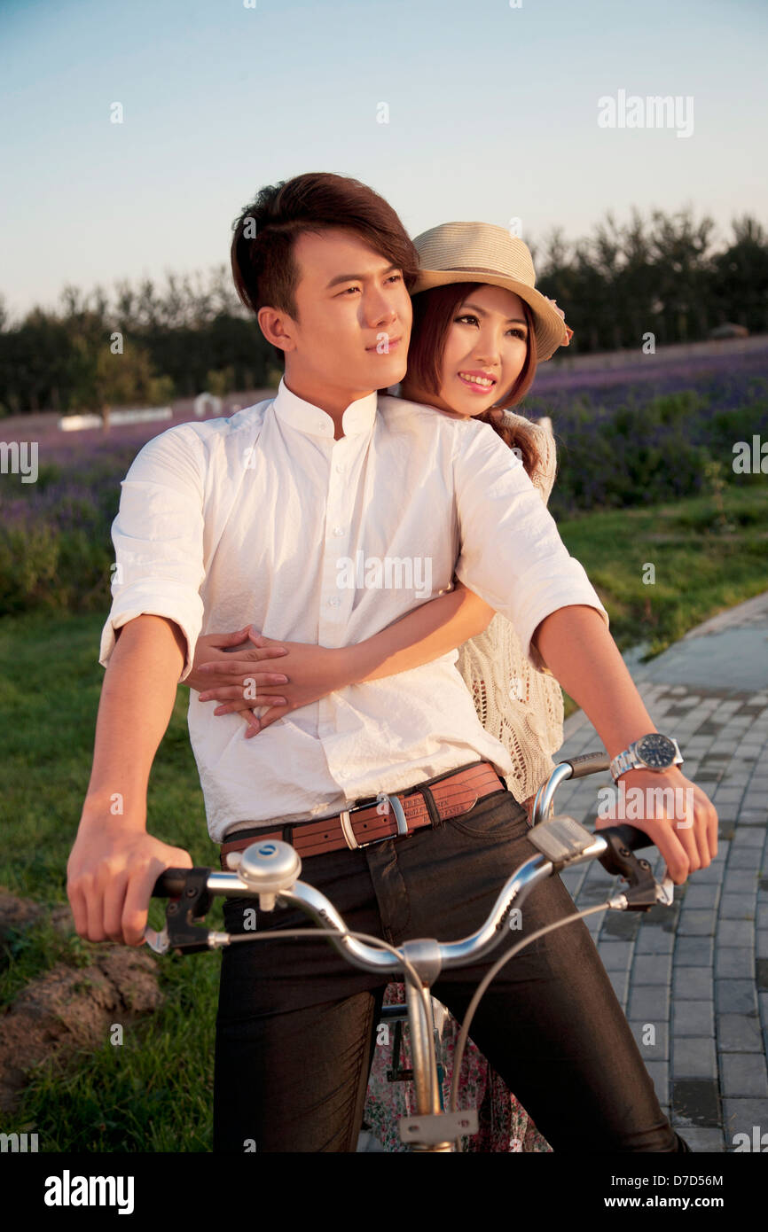 The young couple riding a bicycle Stock Photo - Alamy