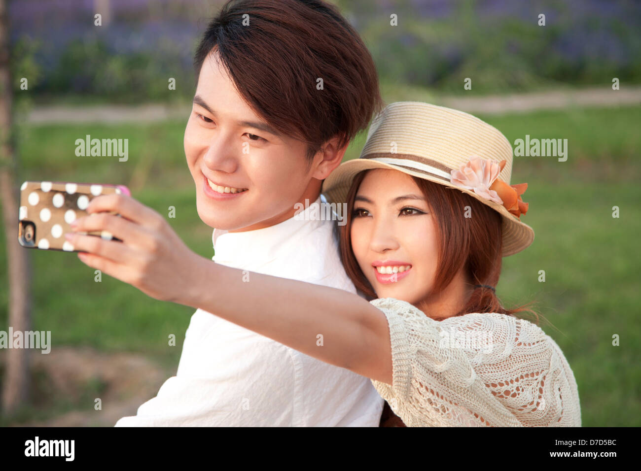 Young couple with mobile phone self-timer Stock Photo - Alamy