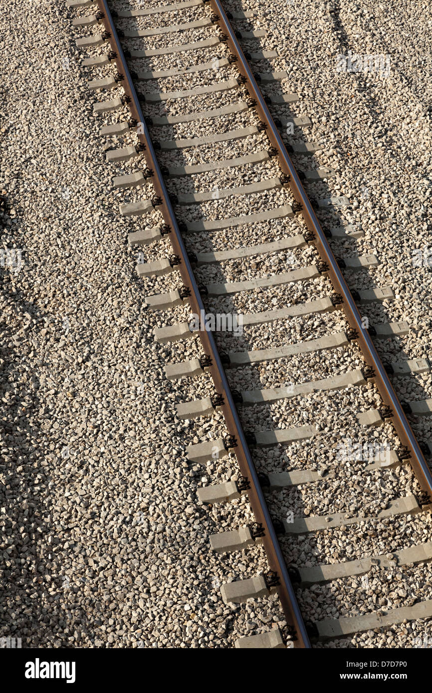 Tilted view of part of a railroad track on gravel Stock Photo - Alamy